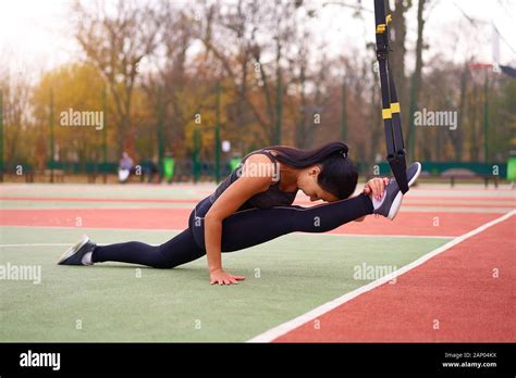 Girl Athlete Training Using Trx Sportground Mixed Race Young Adult