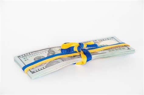 Ribbon In The Form Of The Flag Of Ukraine Tied In A Bow On A Stack Of