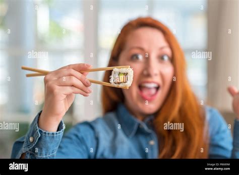 Redhead Woman Eating Sushi Using Chopsticks Very Happy And Excited
