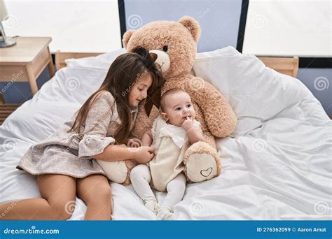 Brother And Sister Smiling Confident Lying Together On Bed At Bedroom