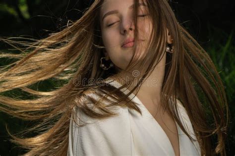Portrait Of A Confident Girl A Brunette Girl In A White Dress Stock