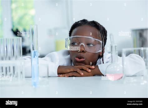 Female Chemist In Lab Testing Liquid In Flask And Tube Conducting Scientific Experiments Stock