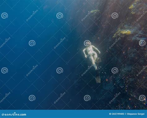 A Beautiful Girl Swims Underwater Girl In Swimsuit Blue Water Stock