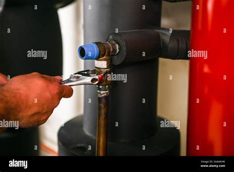 Man Fixing A Pipe With A Wrench Stock Photo Alamy