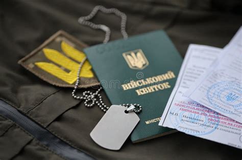 Military Token Or Army Id Ticket With Mobilization Notice Lies On Green Ukrainian Military