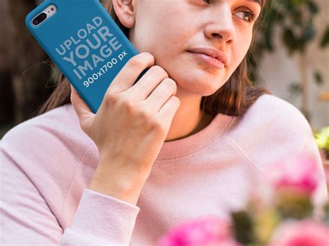 Placeit Mockup Of A Woman Holding A Phone Case Near Flowers