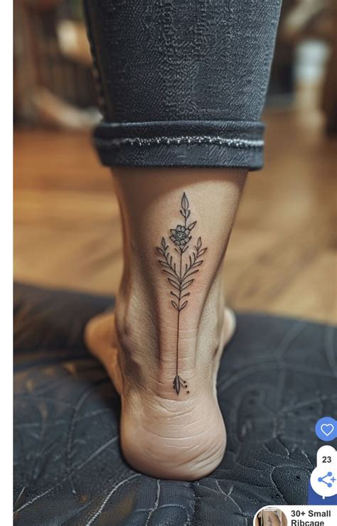 A Womans Foot With A Small Flower Tattoo On The Side Of Her Leg