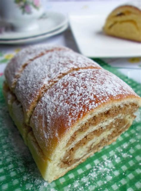 A Close Up Of A Pastry On A Green And White Table Cloth With Other Plates In The Background