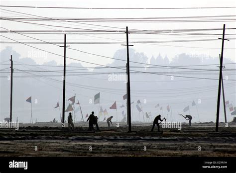 Workers Work On A Foggy Morning Before The Annual Magh Mela Festival