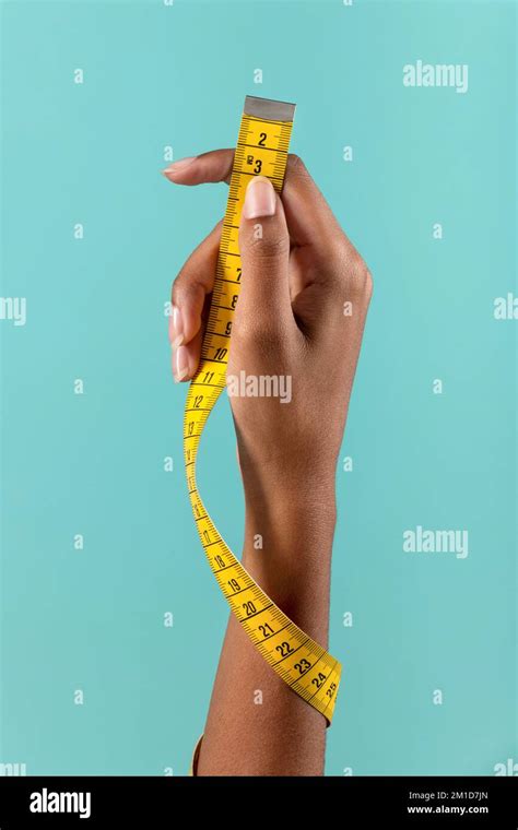 Crop Anonymous African American Female Demonstrating Yellow Measuring
