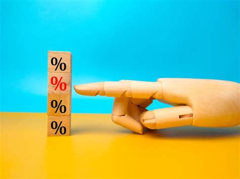 Premium Photo The Wooden Hand Points To The Red Percentinterest Rate