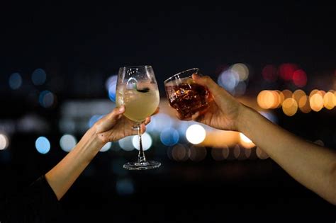 Premium Photo Cheers Girls Clink Glasses Of Cocktails