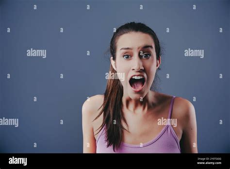 Young Woman Is Experiencing A Moment Of Intense Shock Or Surprise Her