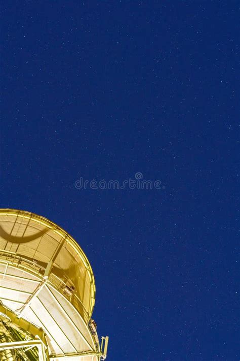 Low Angle Of The Cylindrical Wooden Structure Below The Clear Night Sky