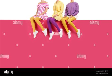 Group Of Women Wearing Bright Tights And Stylish Shoes Sitting On Color