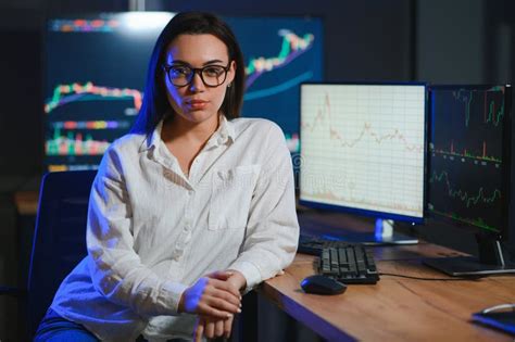 Financial Analyst Working On A Computer With Multi Monitor Workstation