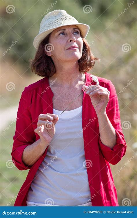 Relaxed Aging Woman Enjoying Summer Wandering In The Countryside Stock