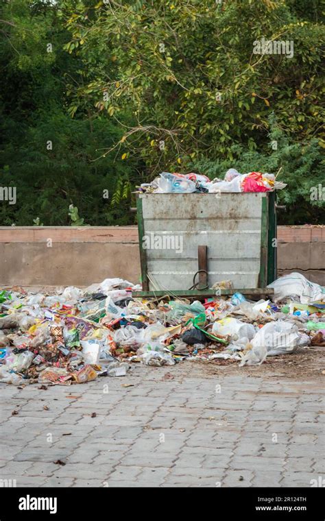 Open Garbage Dust Bin Liter With Plastic Begs And Waste Items At Day Open Garbage Dust Bin Liter With Plastic Begs And Waste Items At Day