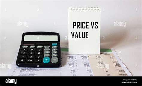 Price Versus Value Text On A Notepad Next To Financial Documents And
