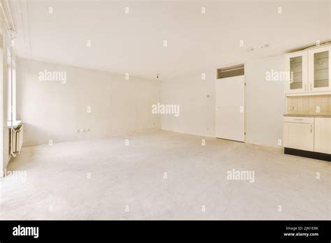 Interior Of Empty White Kitchen With Windows And Wooden Parquet Floor