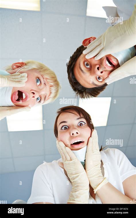 Dentists During Dental Treatment Looking Shocked At Patient Pov Stock