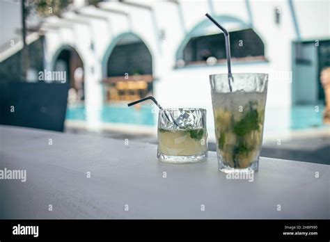 Mojito Cocktail At The Edge Of A Resort Pool Concept Of Luxury