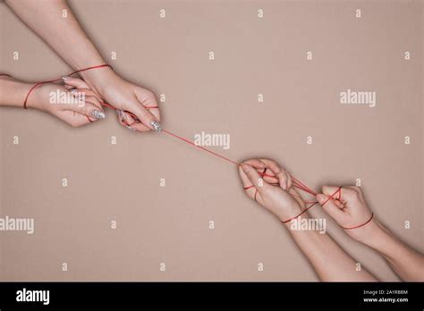 Top View Of Women Pulling Red String On Beige Background Stock Photo Alamy