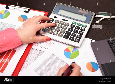 Woman Working With Calculator In Office Stock Photo Alamy