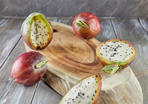 Premium Photo Peruvian Apple Cactus Fruits Whole And Cut On Wooden