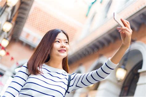 Young Attractive Asian Woman Taking Her Selfie With Her Smart Ph Stock