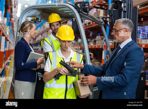 Businessman Controlling Digital Device Of Worker Stock Photo Alamy