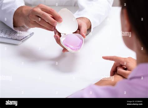 Gynecologist Consulting Woman On Diaphragm Contraception And Birth