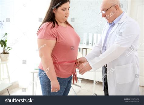 Male Doctor Measuring Waist Overweight Woman Stock Photo 1115769632