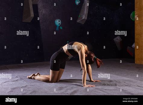 Athletic Young Woman Practicing Yoga Cat Cow Pose In Indoor Climbing