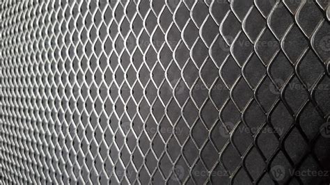 patrón sin costuras de malla metálica Textura de malla de metal negro sobre un fondo negro