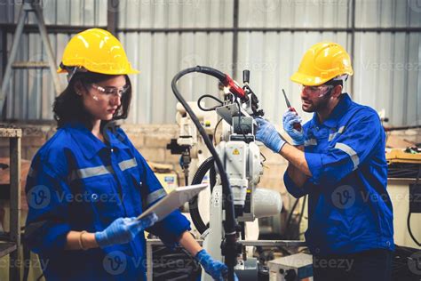 Two Engineers Mechanic Using Computer Controller Robotic Arm For