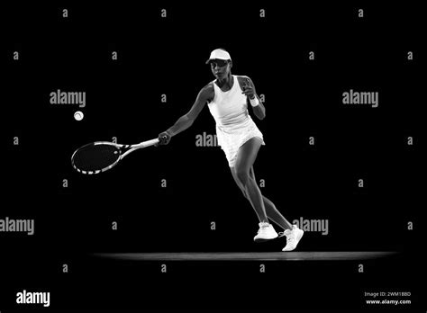 Professional Tennis Player Preparing To Hit Tennis Ball In Action