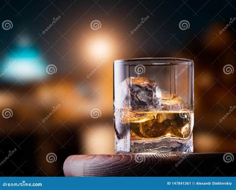 Glass Of Whiskey With Ice On A Blue Background Royalty Free Stock