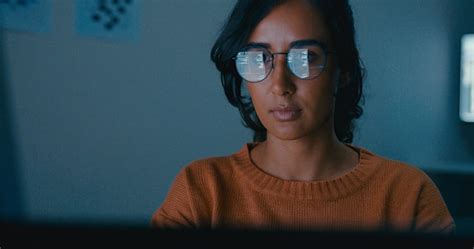 Female Computer Programmer Works On Complex Software Development Tasks At Her Home Office Late