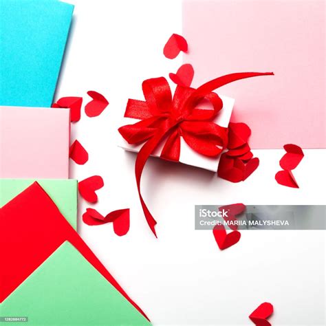 발렌타인 데이 빨간색 컷 종이 하트와 빨간 활 선물 상자와 여러 화려한 봉투와 빈 시트 러브 레터를 작성합니다 메시지맨 위 보기입니다 복사 공간을 복사합니다 발렌타인 컨셉