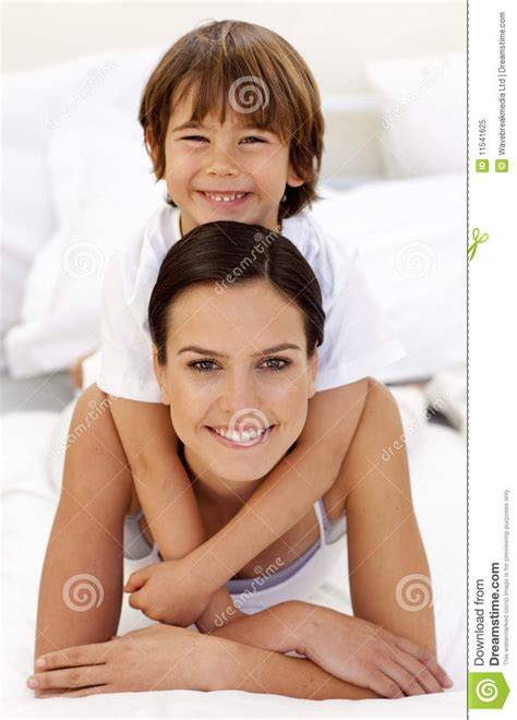 Son Hugging His Mother In Bed Happy Son Hugging His Mother In Bed
