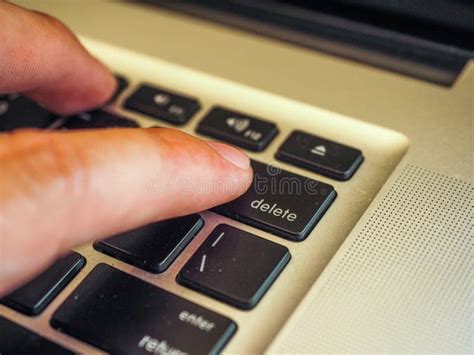Finger Pushing Delete Button On A Keyboard Of Computer Stock Image