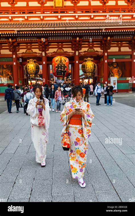 Japan Honshu Tokyo Asakusa Sensoji Temple Women In Kimono Texting While Walking In Temple