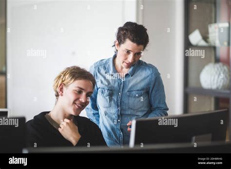 Confident Female Mature Teacher Looking At Computer Monitor While