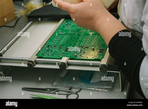 Female Computer Expert Professional Technician Examining Board Computer In A Laboratory In A