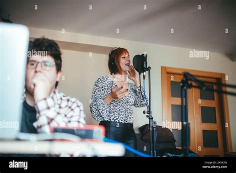 Female Singer Performing Song Into Professional Mic With Pop Filter