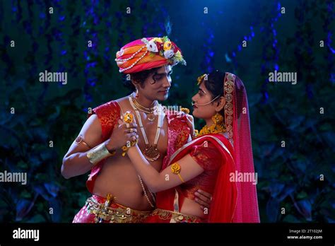 Young Man And Woman Dressed Up As Radha And Krishna And Romancing On
