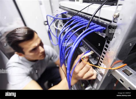 Man Connecting Network Cables To Switches Stock Photo Alamy