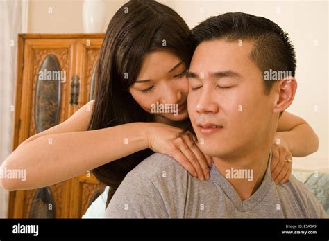 Chinese Woman Giving Babefriend Shoulder Massage Stock Photo Alamy