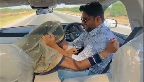 Man In His Fast Moving Auto Mode Car Making Romance With His Wife Video Goes Viral On Social